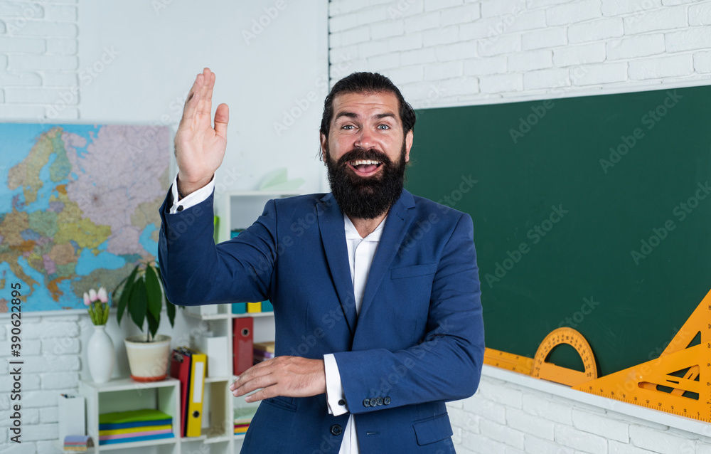 hello. happy man with beard wearing formal suit. process of studying ...