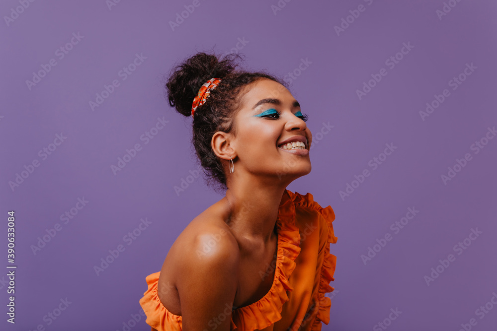 Blissful black woman in summer dress laughing on violet background ...