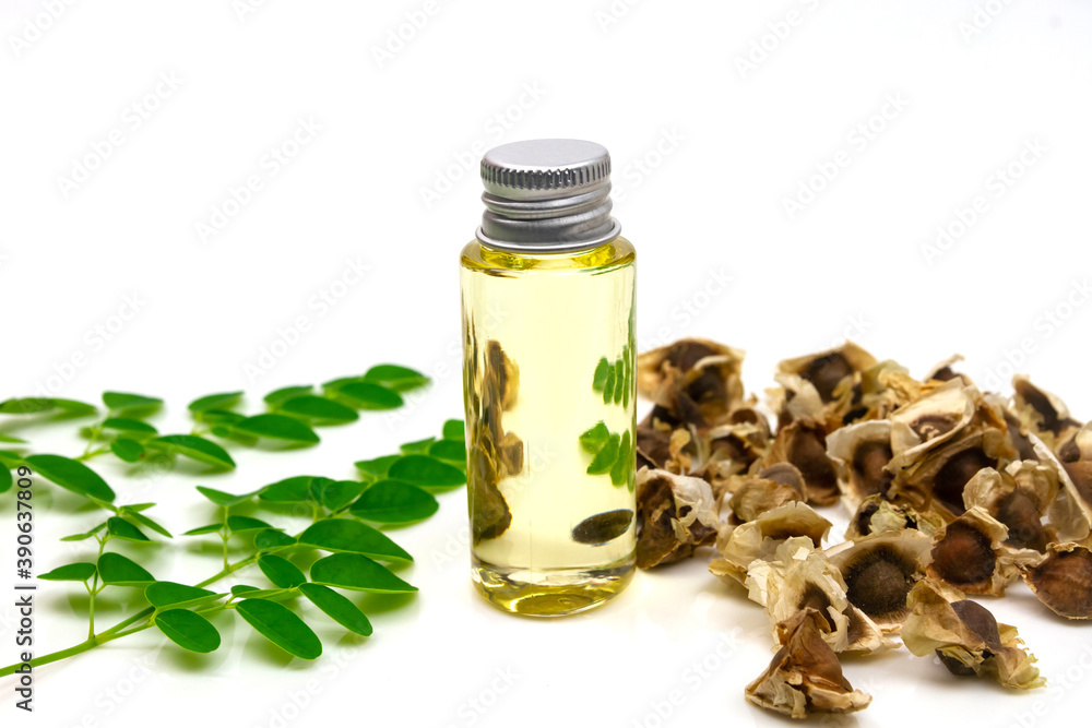 Oil of Moringa in bottle, green leaves and seeds isolated on white ...