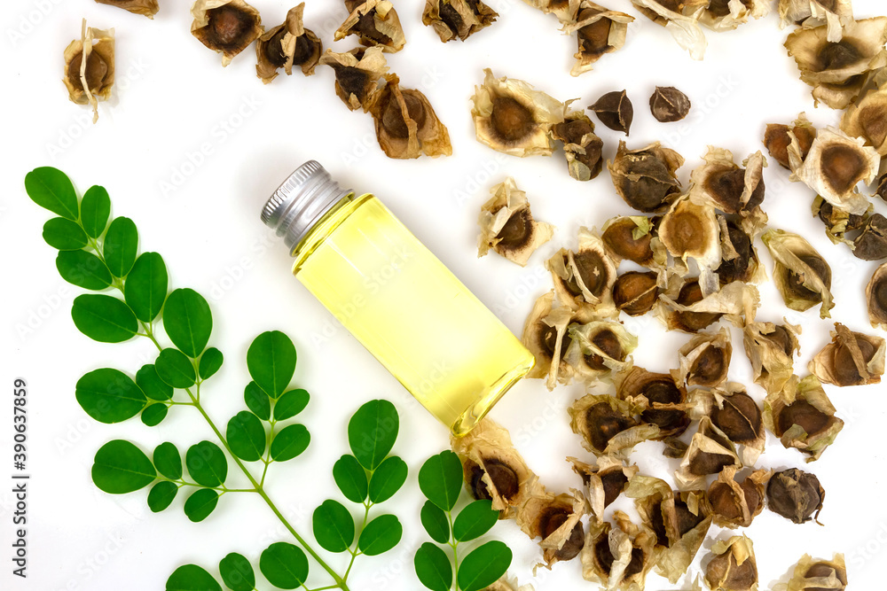 Oil of Moringa in bottle, green leaves and seeds isolated on white ...