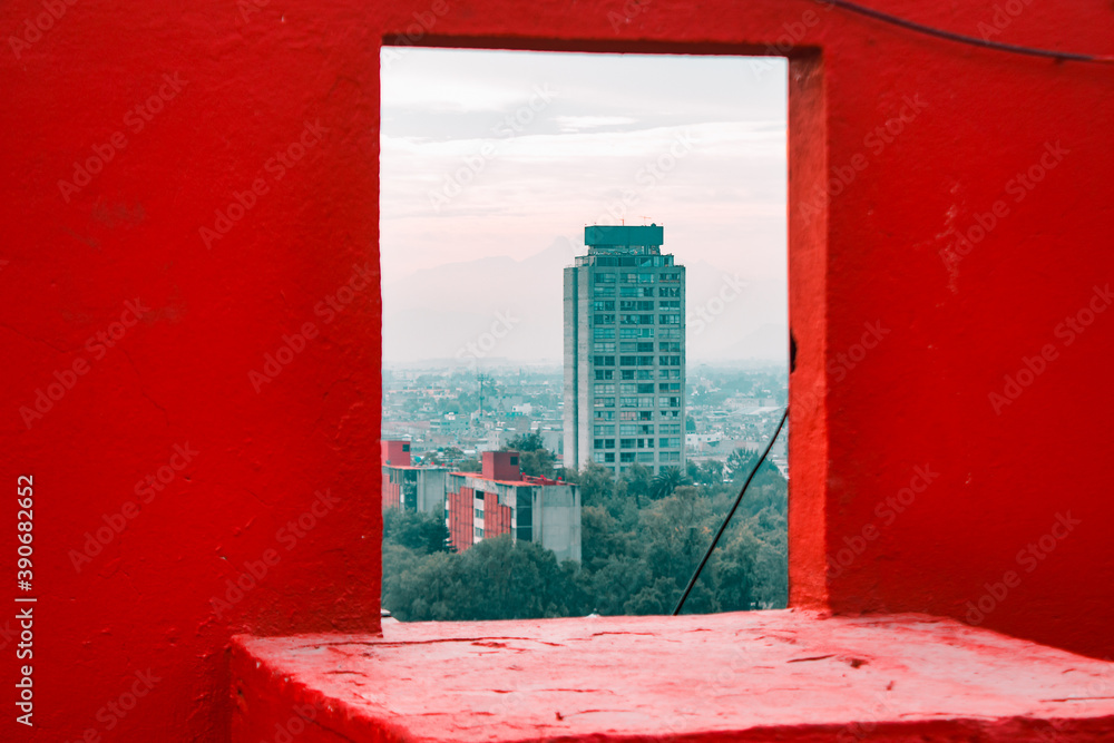 Hole in a red wall framing a building in Tlatelolco mexico Stock Photo ...