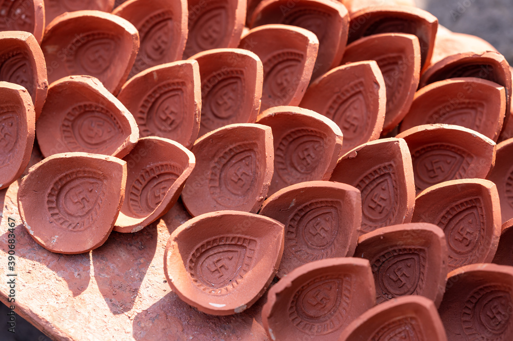 Traditional diya made of clay and mud placed in sunlight at Diya ...