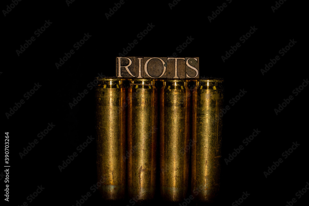 Riots text formed with real authentic typeset letters on 50 caliber BMG ...