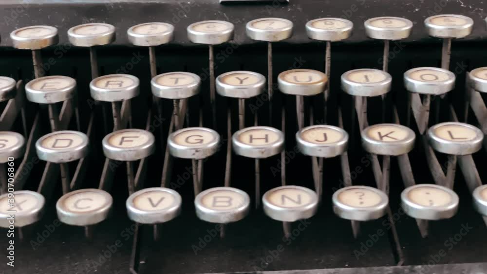 close-up view of the round keys of an old dusty black typewriter ...