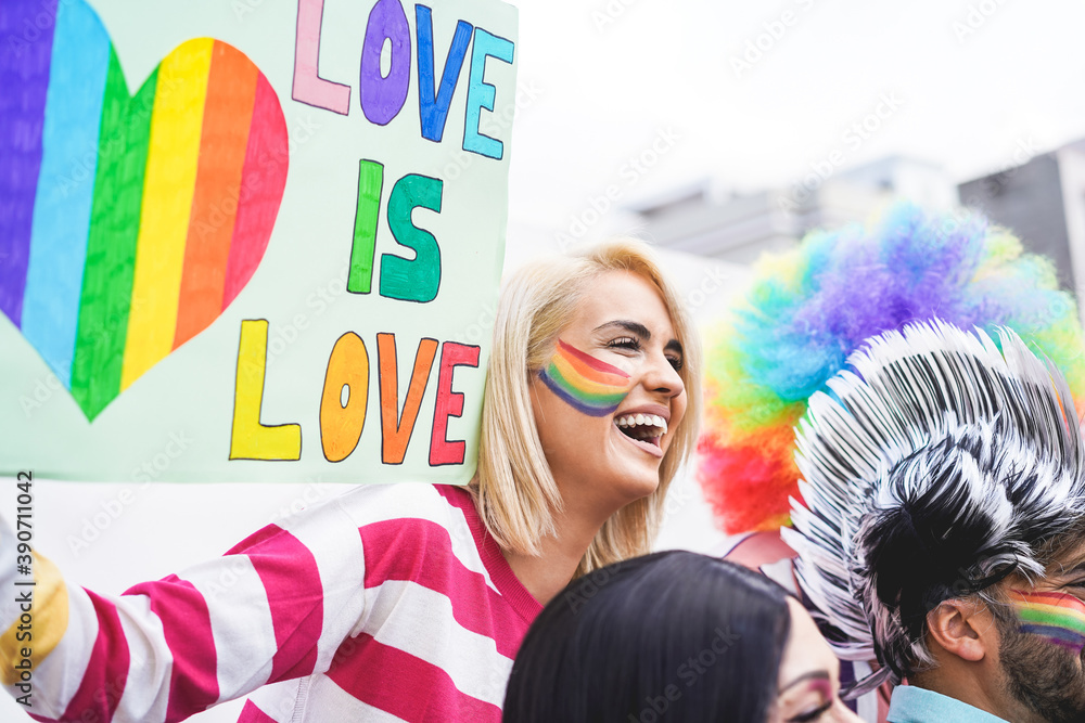 Girl holding a banner at a gay pride parade - Lesbian woman having fun ...