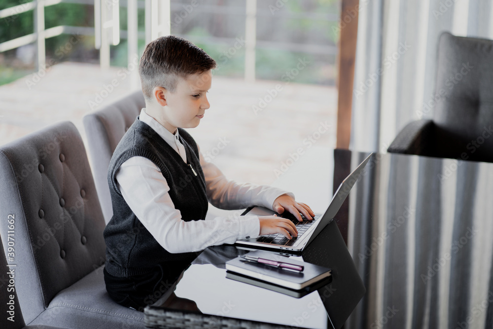 smart schoolboy boy with dark hair of European appearance. dressed in a ...