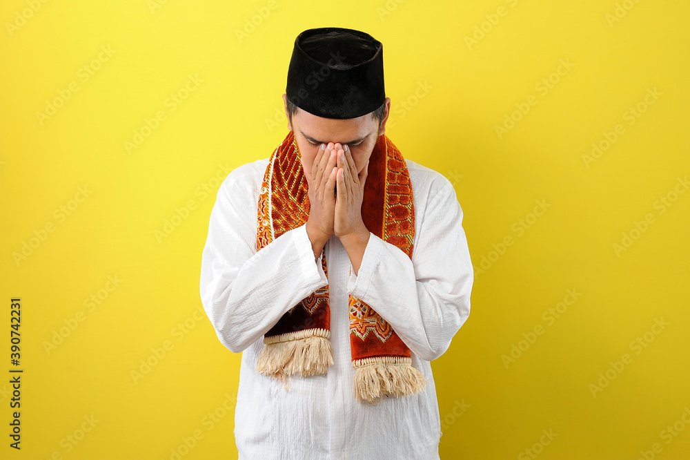 Young Asian Muslim man feel sad with covering his face with hands. Copy ...