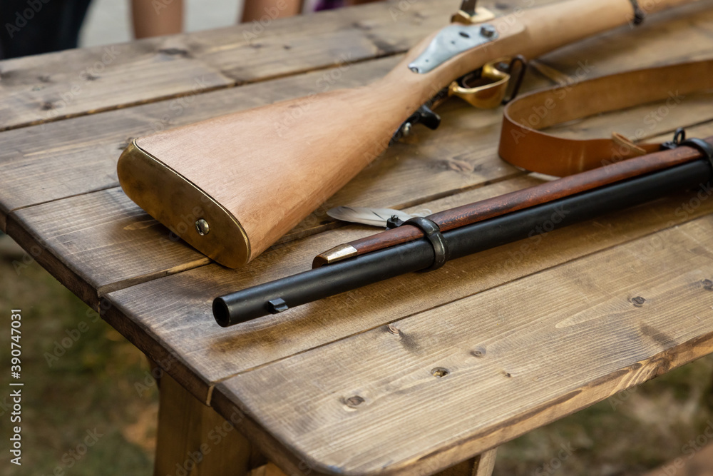 medieval weapon musket butt and smoothbore muzzle on a wooden table ...