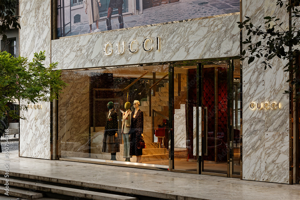 Gucci fashion store façade front view with mannequins displayed in shop ...