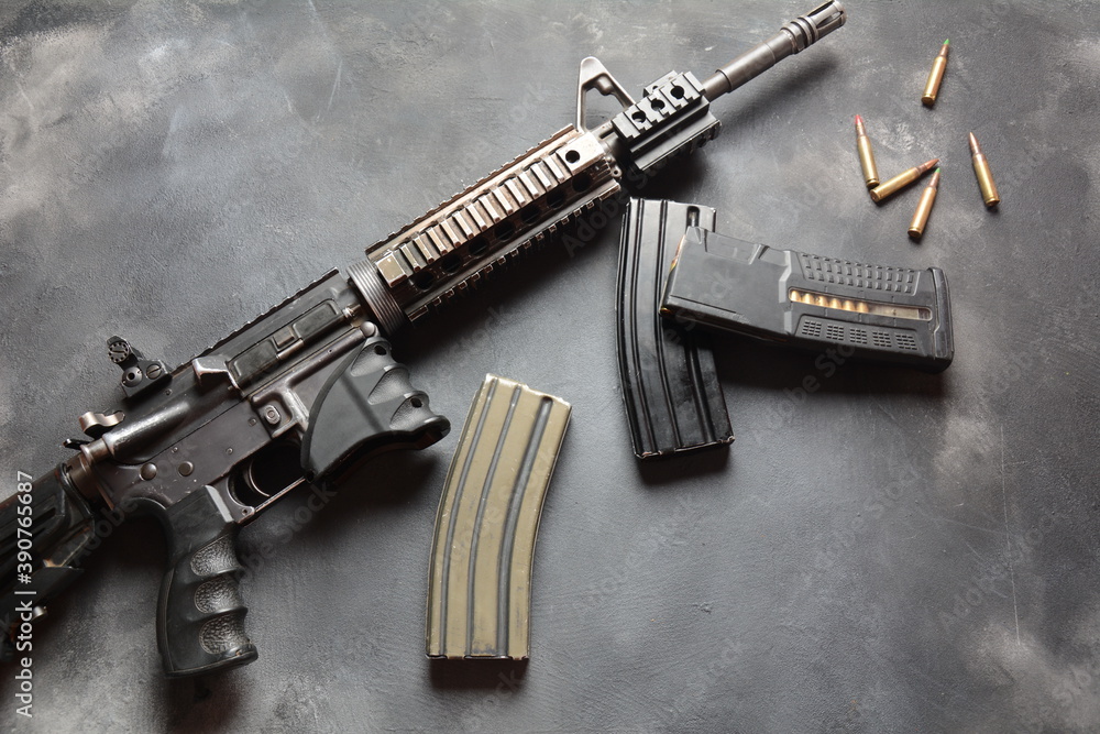 Assault rifle (M4A1) with ammunition on camouflage uniform,and military ...
