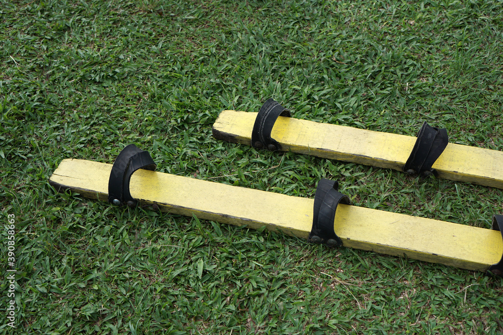 Wooden sandals that are used by several people at once in Indonesian ...