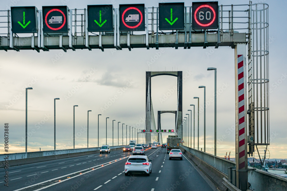 Vehicles circulating on a suspension bridge, with illuminated panels ...