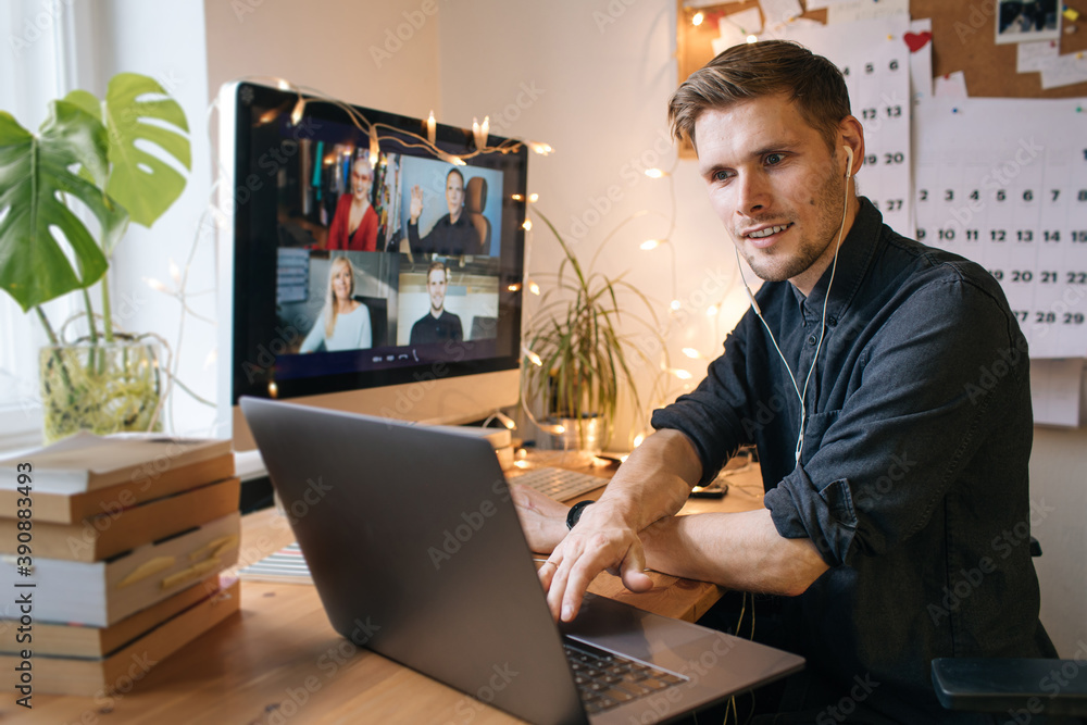 Young man having Zoom video call via a computer in the home office ...