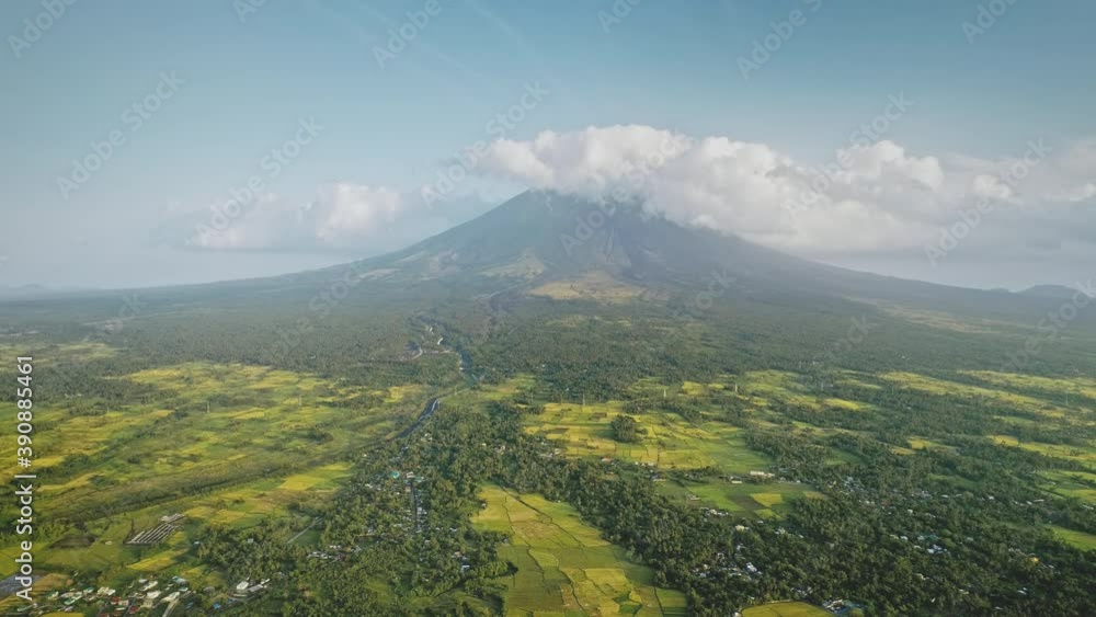 Green tropic farmlands at volcano hillside valley aerial. Legazpi town ...