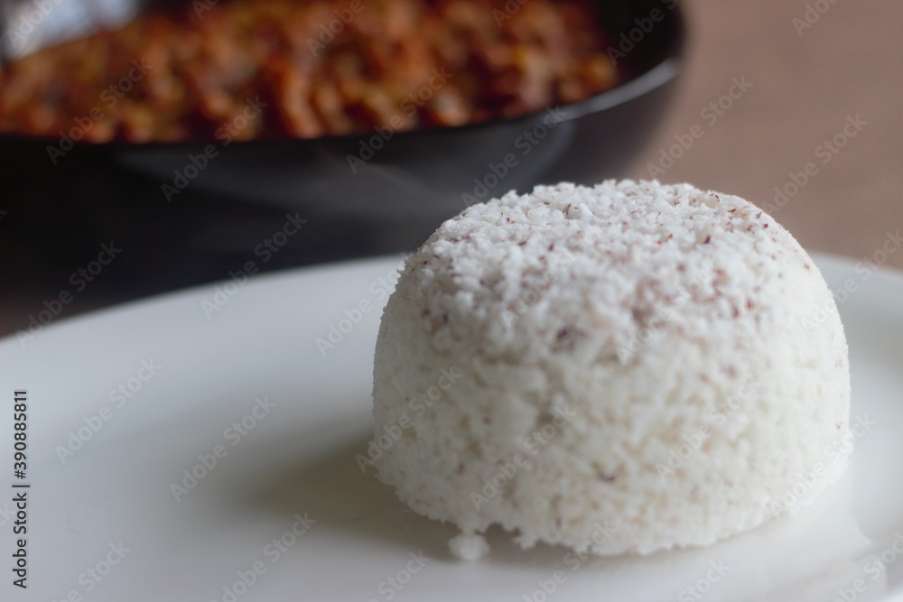 Steamed rice cake with layers of freshly grated coconut in between, a ...