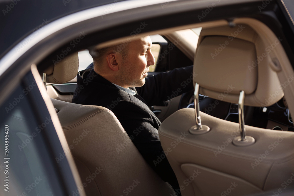 Young man driver behind the wheel of a car, driving car. Buying a car ...