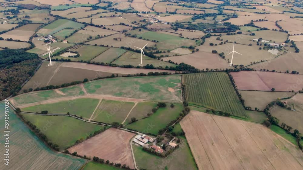 drone view of Eolian farm renewable energy in fresh green field against ...