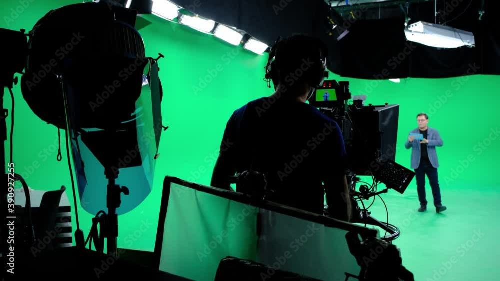 The cameraman follows the announcer in a professional green screen ...