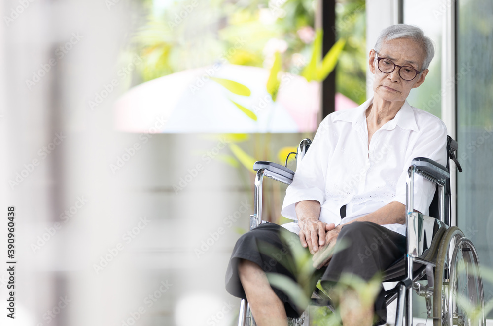 Sad And Depressed Asian Senior Woman Sitting Alone In Wheelchair With