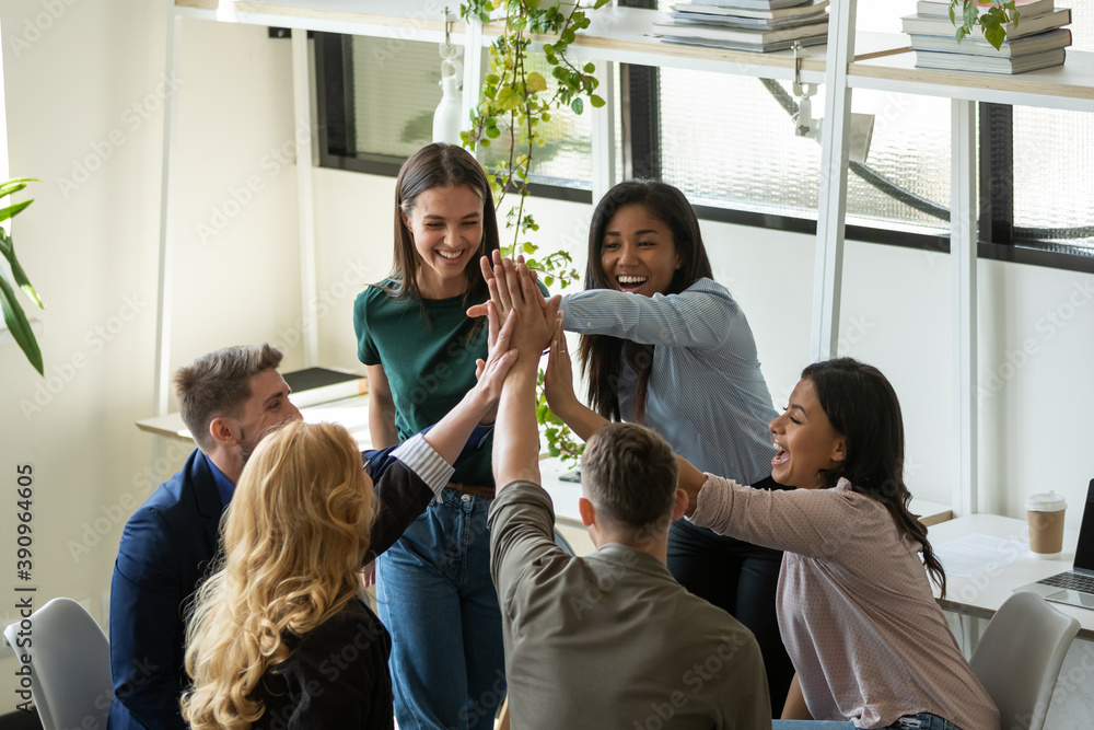 Together we are the power. Laughing excited business team colleagues of ...