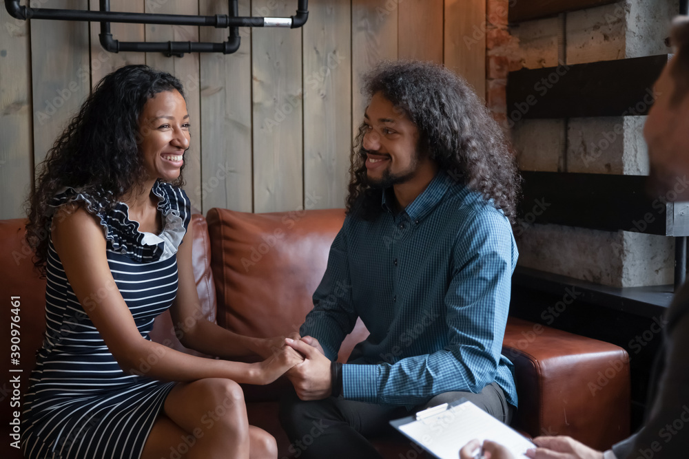 Reconciliation of spouses. Hopeful young black family couple sitting on ...