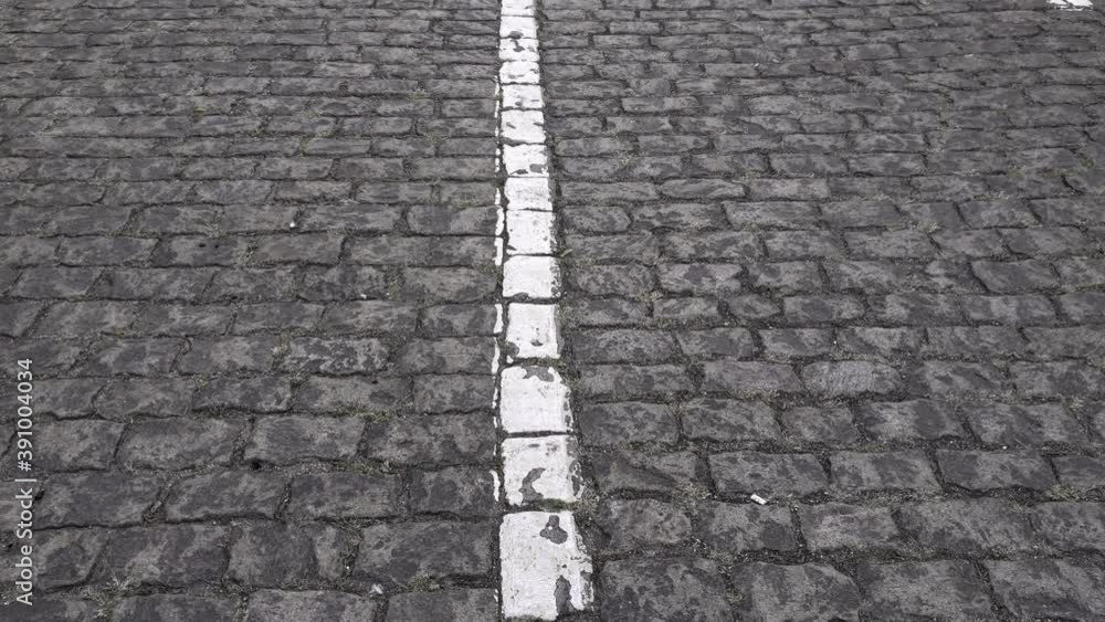 Ancient stone paving road in old town. Cobblestone pavement with ...