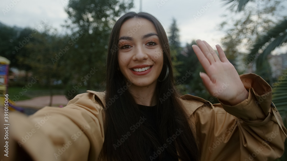 Beautiful young smiling face woman holding camera or phone in hand and ...