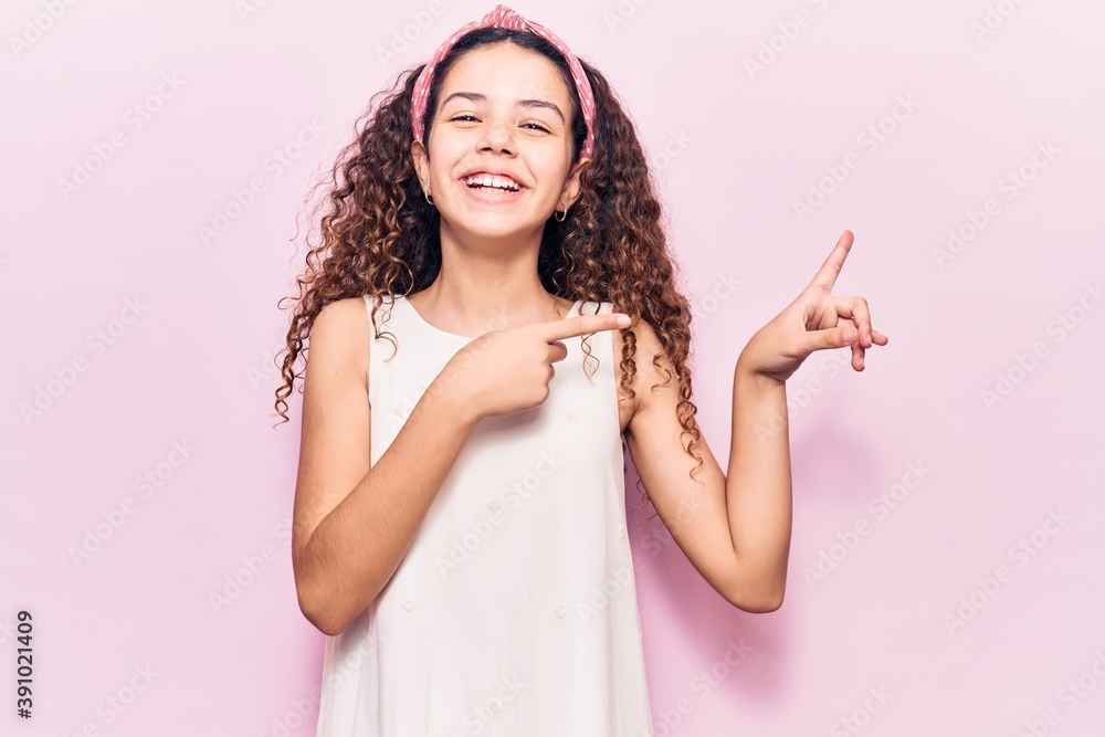 Beautiful kid girl with curly hair wearing casual clothes smiling and ...