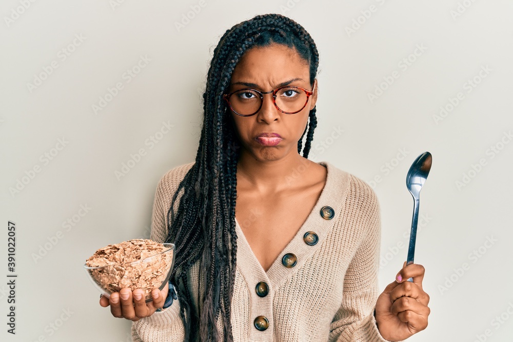 African american woman with braids eating healthy whole grain cereals ...