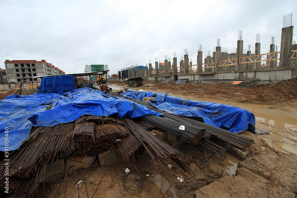 Tall building under construction with scaffolds. Construction site ...