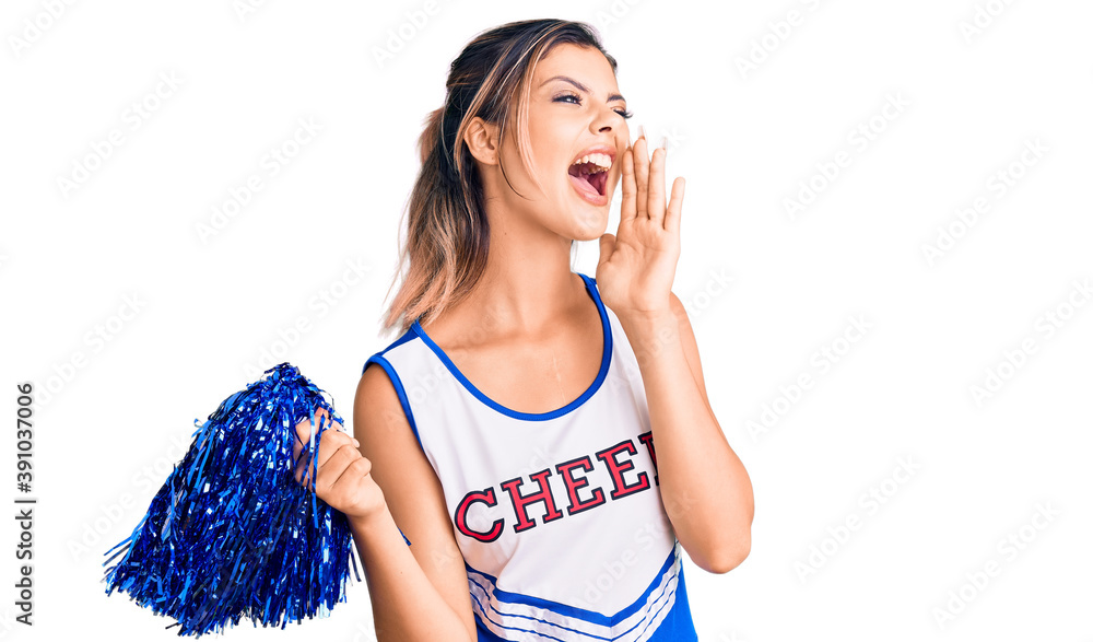 Young beautiful woman wearing cheerleader uniform shouting and ...