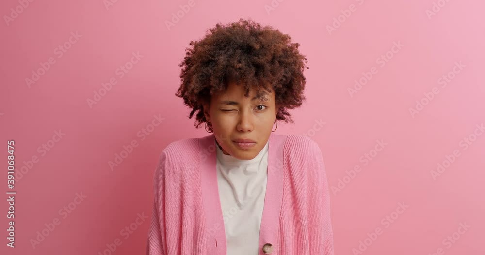 Scared young Afro American woman afraids of looking at something closes ...
