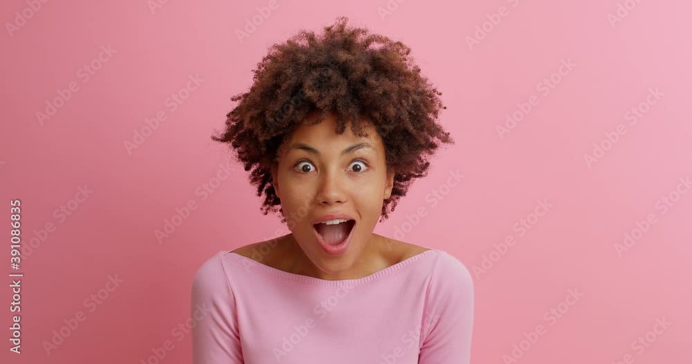 Amazed young Afro American woman looks with surprised cheerful ...