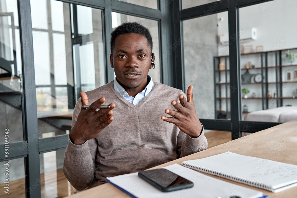 African business man, coach, executive wearing headset talking to ...