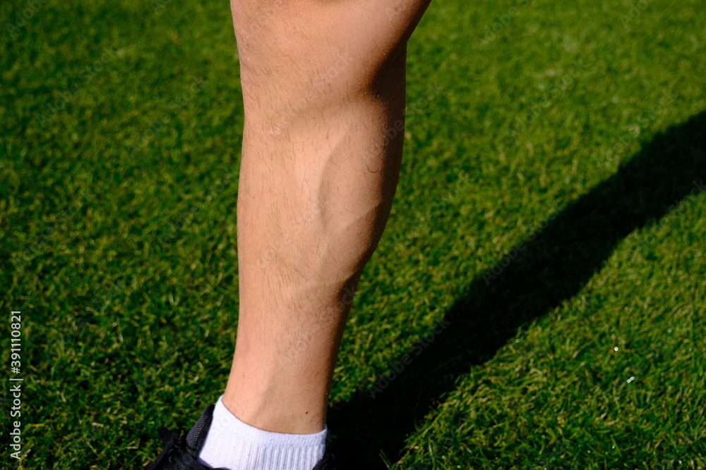 leg veins that are clarified after sports with green background. young ...
