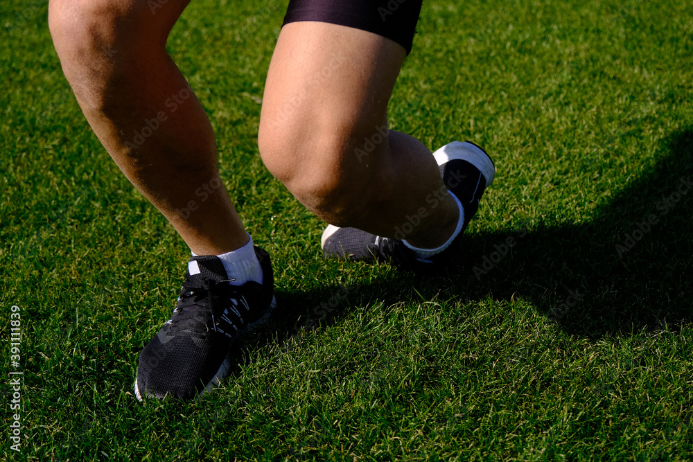 an athlete with an ankle injury during running. he is almost falling to ...