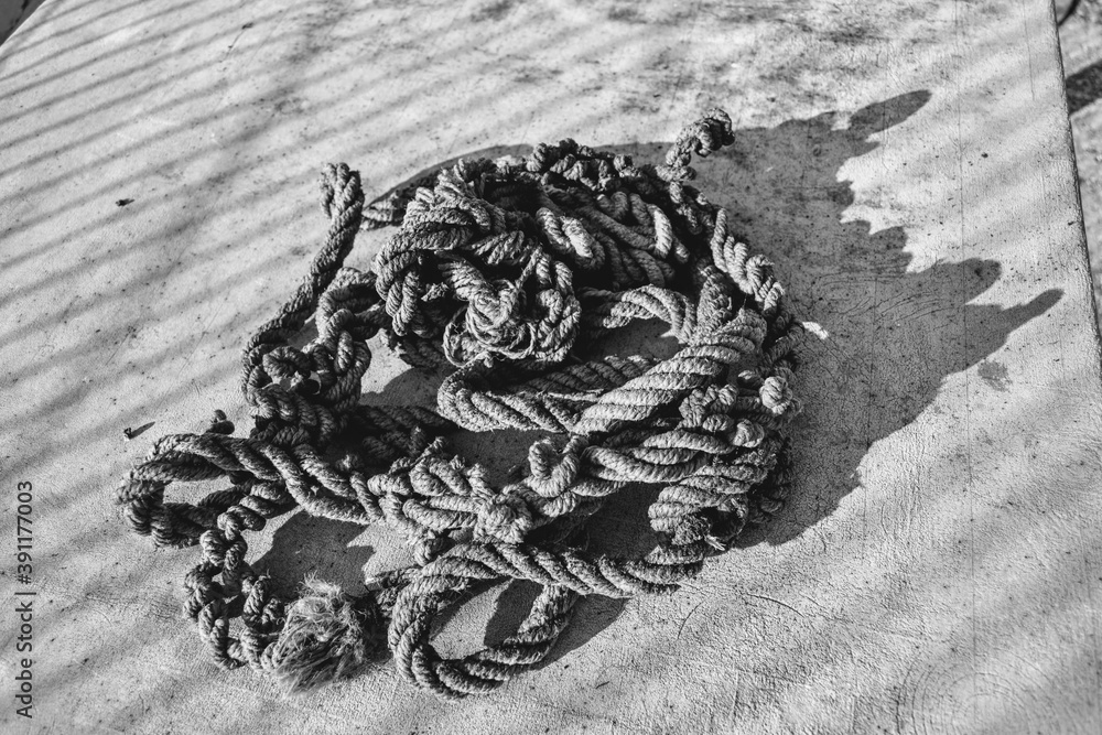 Rope and shadows during sunny day.. An old and frayed rope standing in ...