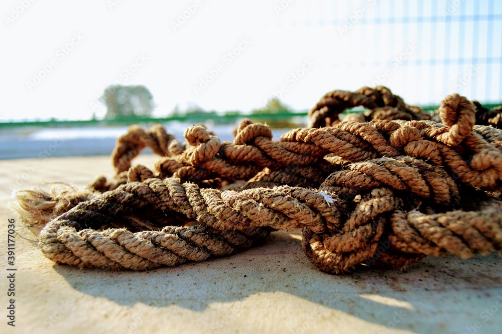 Rope and shadows during sunny day.. An old and frayed rope standing in ...