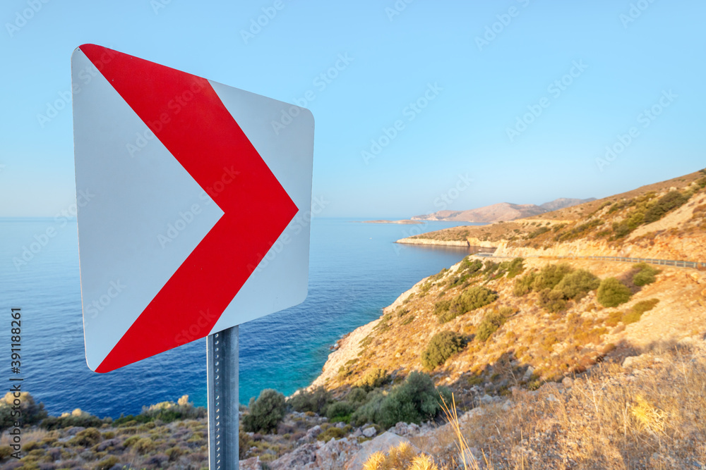 Warning road sign at the sharp turn of the serpentine and winding ...