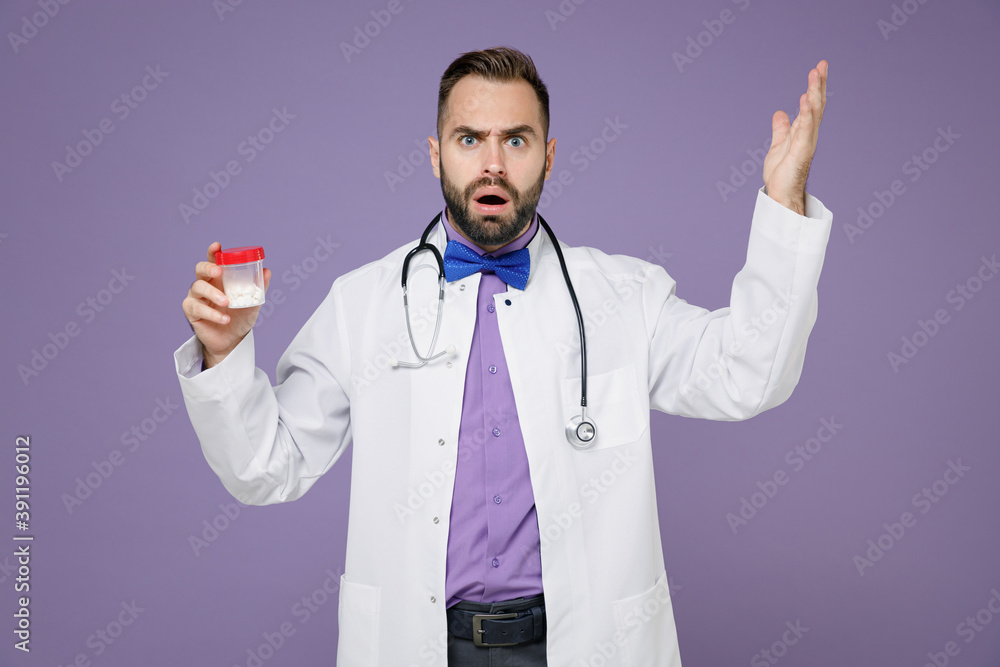 Shocked young doctor man in white medical gown stethoscope hold ...