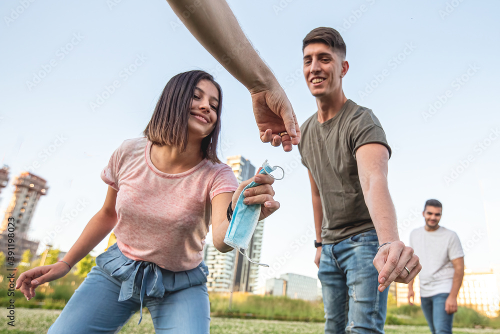 young group of people playing capture the flag on a meadow , whoever ...