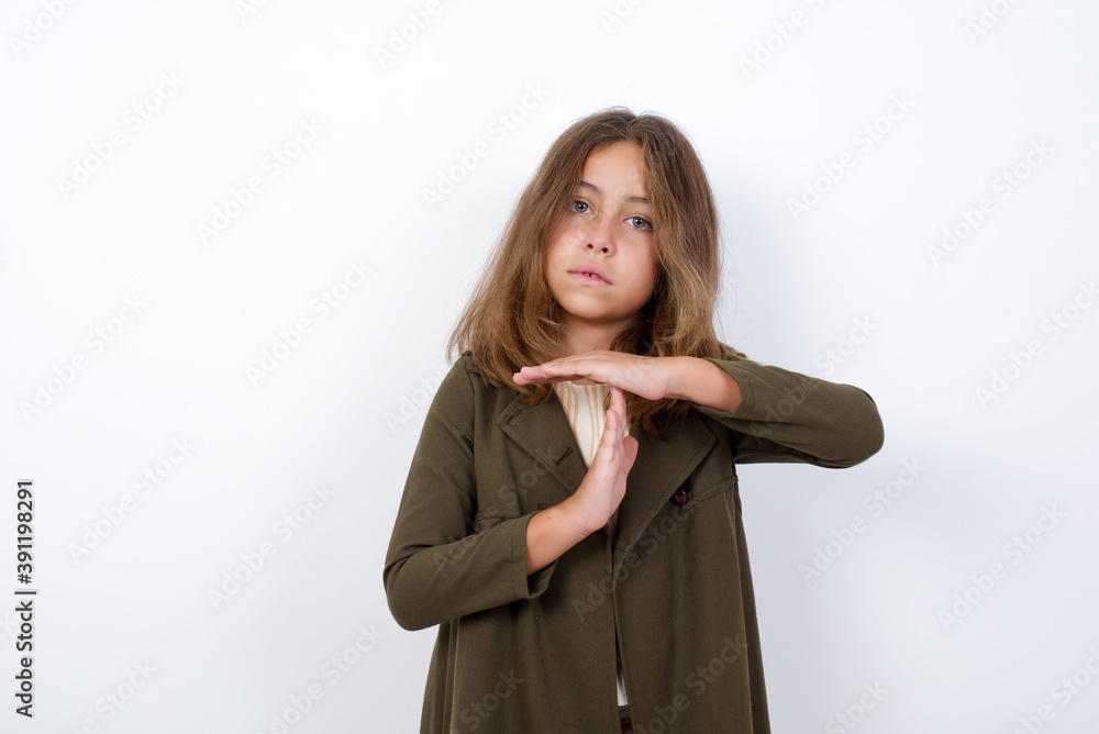 Beautiful little girl standing against white background, feels tired ...
