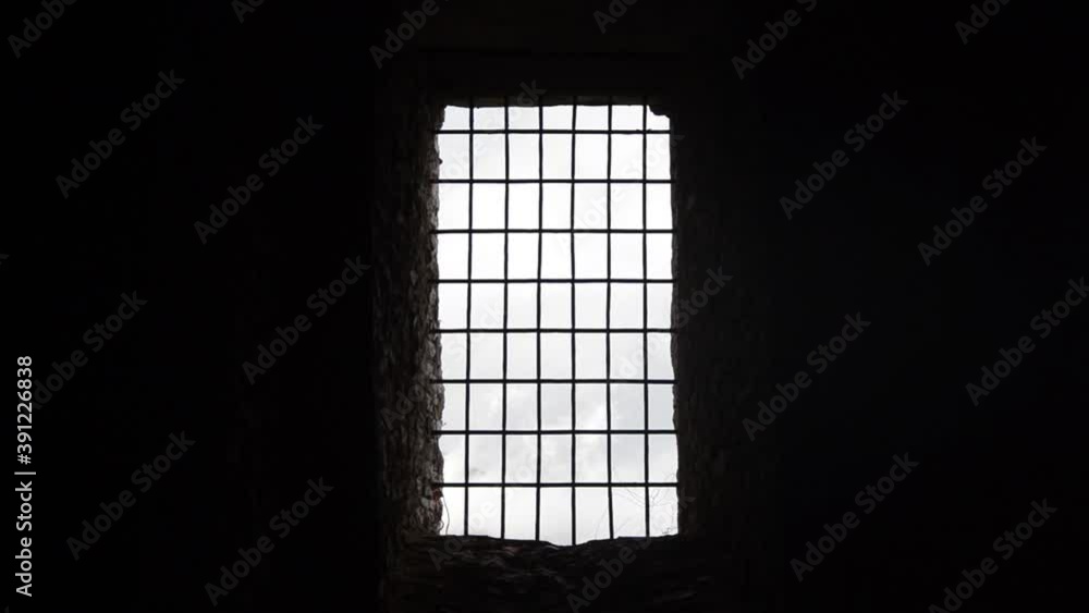 Window in old prison cell. Metal bars in jail. Medieval prison with ...