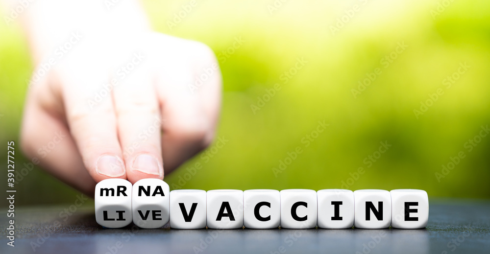 Hand turns dice and changes the expression "live vaccine" to "mRNA ...