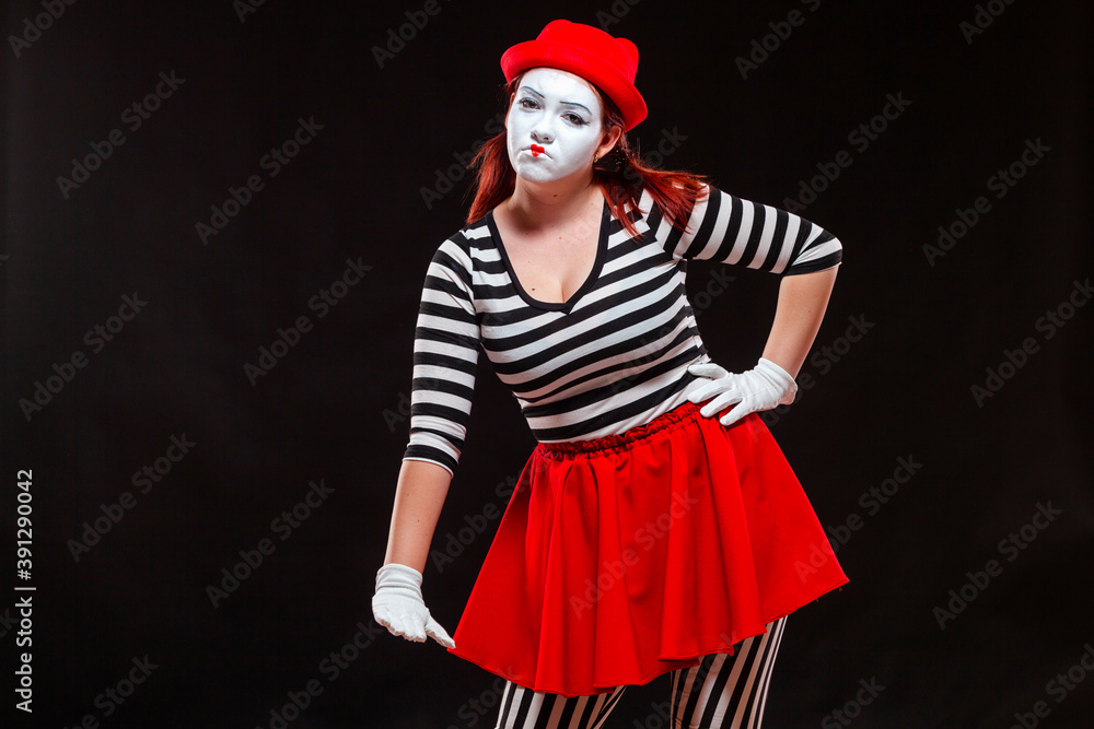 Portrait of female mime artist performing, isolated on black background ...