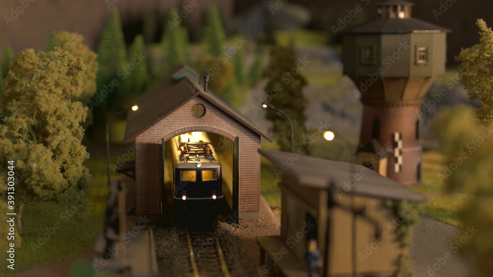Train in a railway shed. Miniature model of lokomotive on the railroad ...