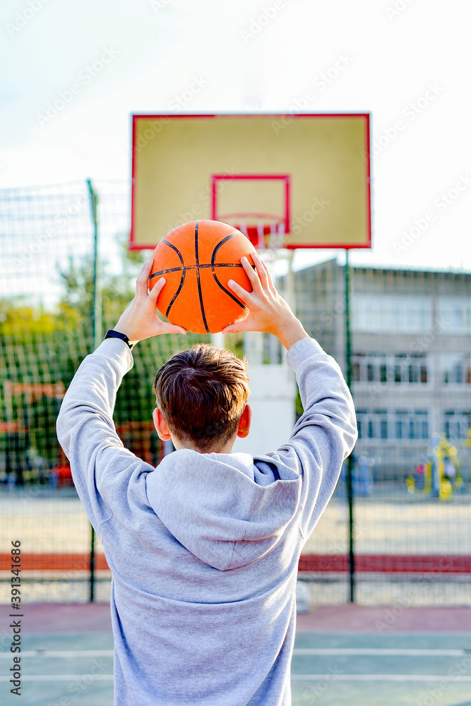 The guy is holding a basketball in his hands and is going to throw it ...