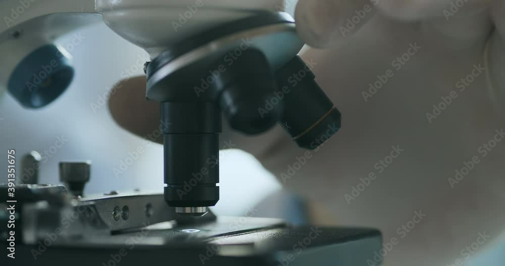 Close-up shot of microscope at laboratory. Researchers working in lab ...