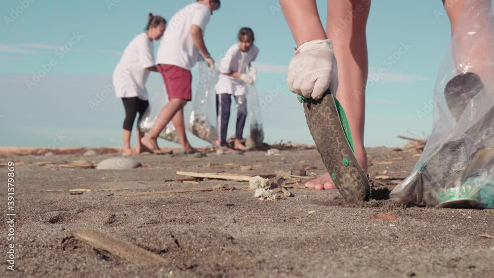 Low-section footage of man walking to thrown half in sand flip flop and ...