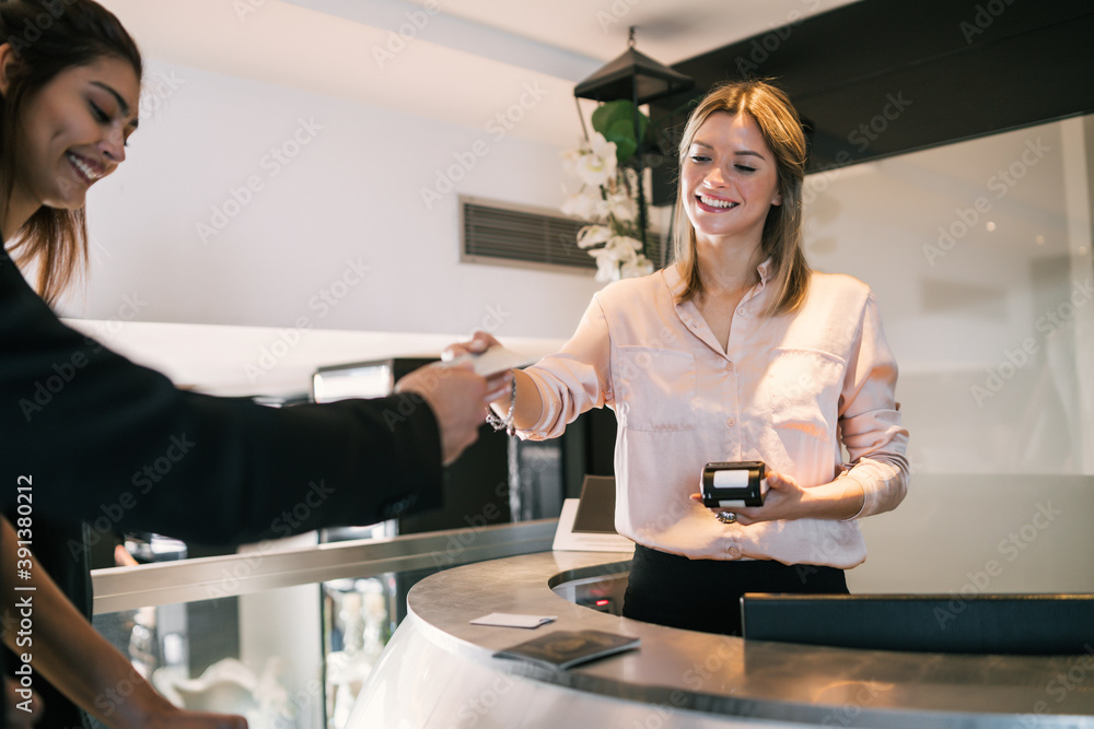 Guest makes card payment at check-in at reception. Stock Photo | Adobe ...